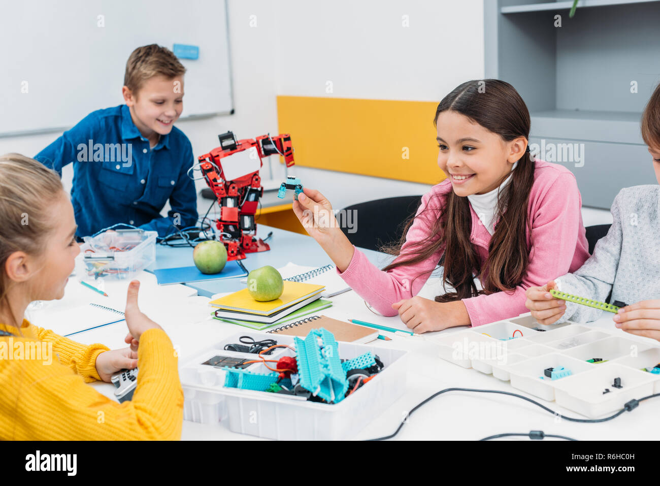 happy schoolchildren working on robot at STEM robotics lesson Stock ...