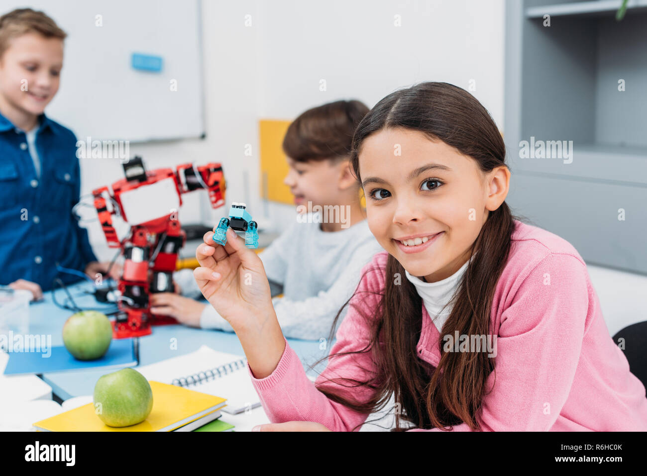 child shows robot detail at STEM robotics lesson Stock Photo - Alamy