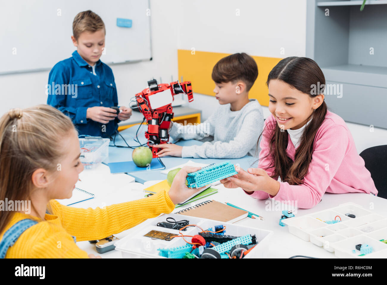 happy schoolchildren working on robot at STEM robotics lesson Stock ...