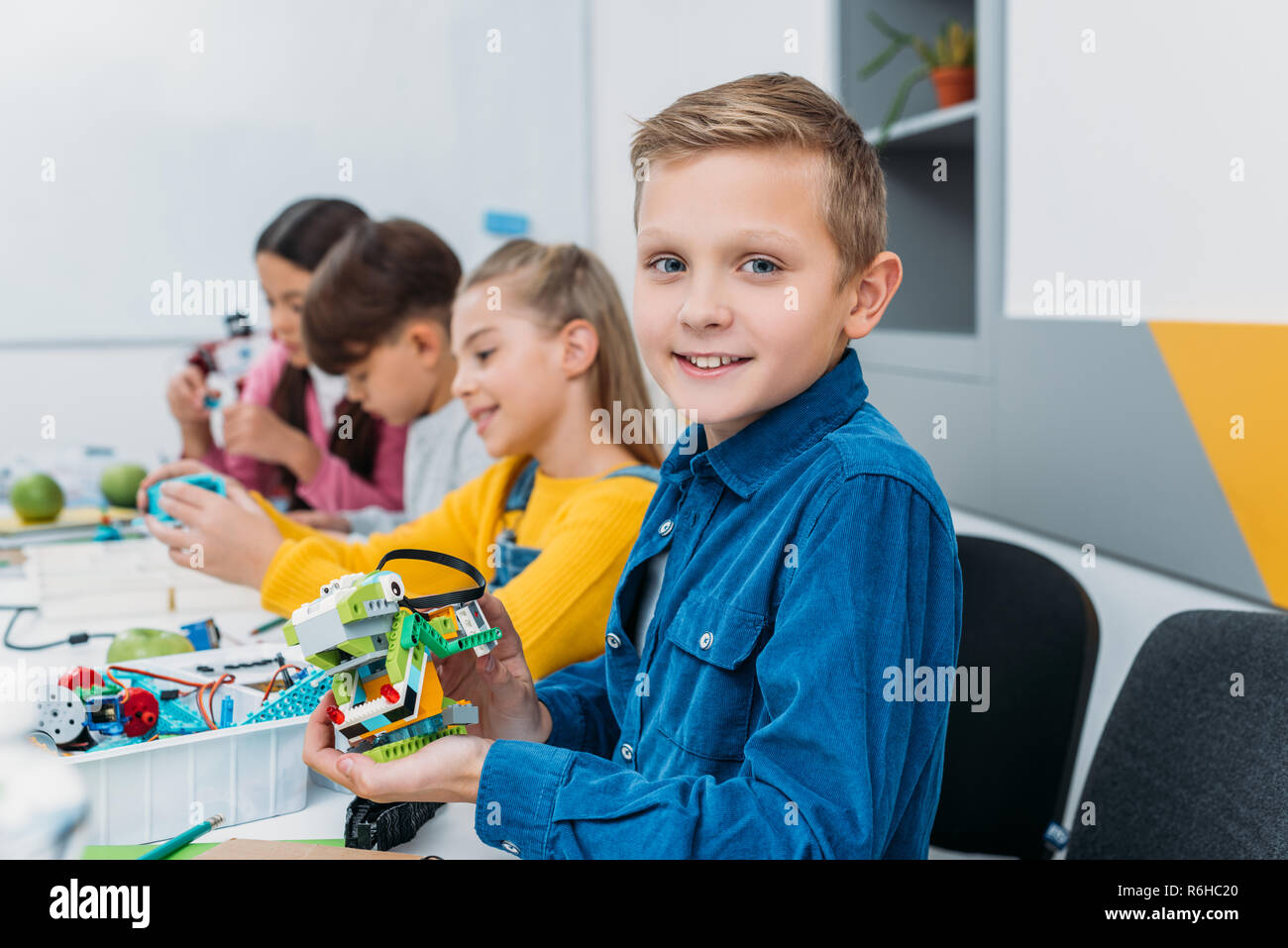 boy showing colorful robot during STEM robotics lesson Stock Photo - Alamy