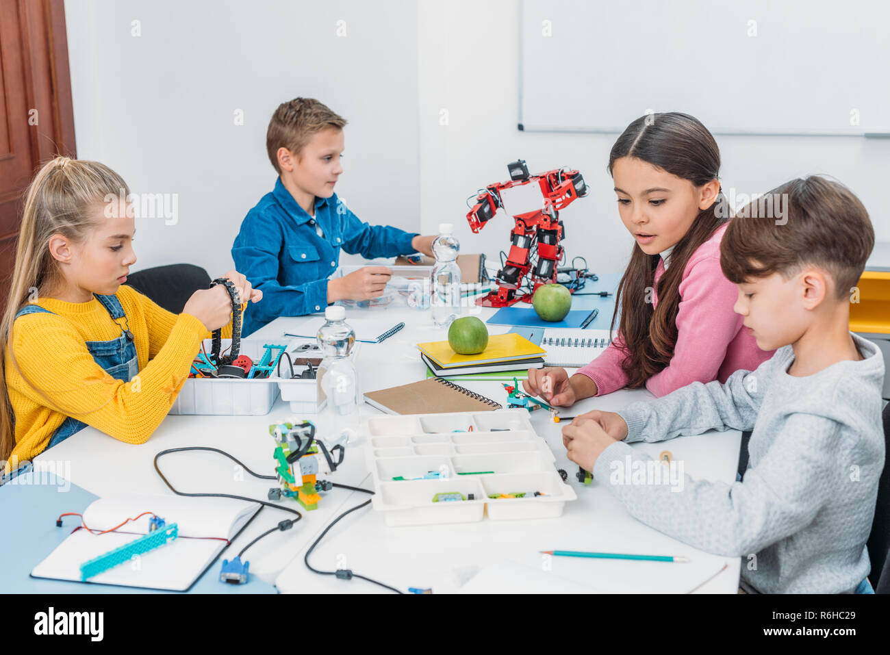 attentive schoolchildren working on robot at STEM robotics lesson Stock ...