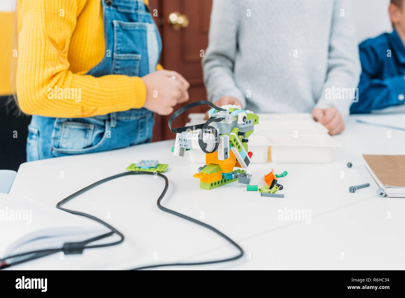 partial view of children working together on STEM project in classrom ...