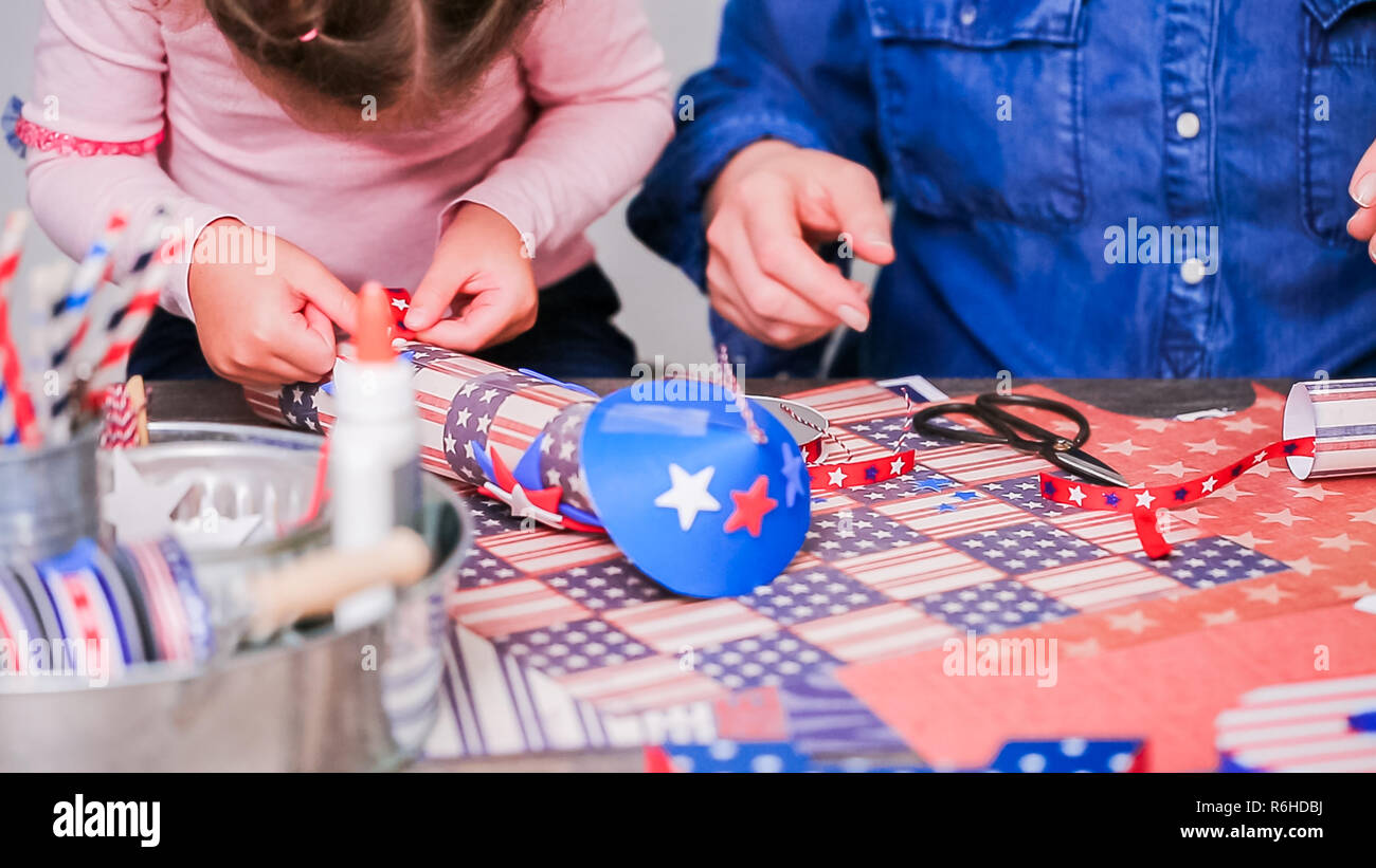 Step by step. Mother and daughter making paper firecrackers for July ...