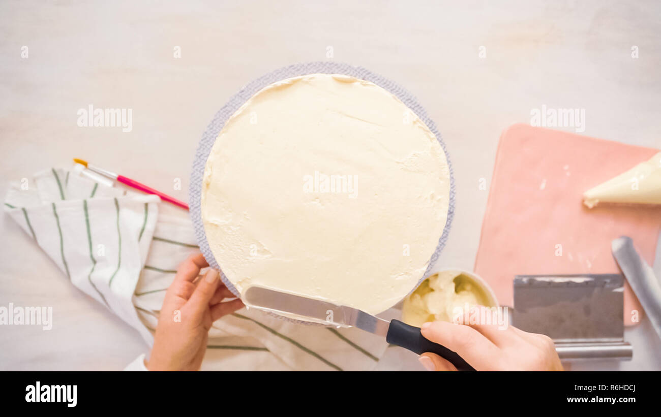 Flat lay. Frosting pink and purple cake with a white buttercream icing ...