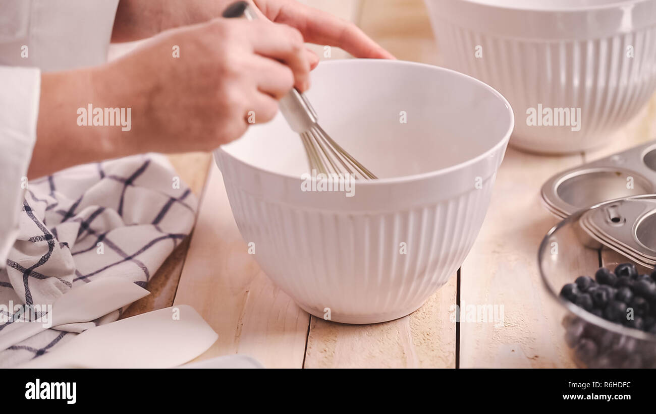 Mixing ingredients together in mixing bowl for blueberry muffins Stock ...