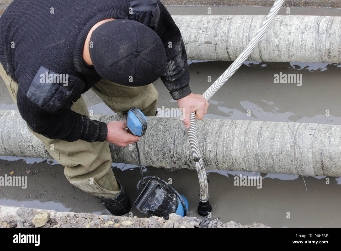 A worker from the emergency water utility brigade holds a pump and ...