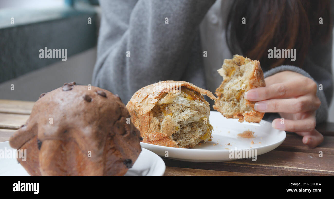 Eating bread in coffee shop Stock Photo - Alamy