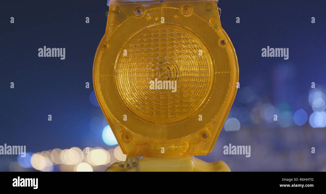 Caution yellow light at night Stock Photo - Alamy