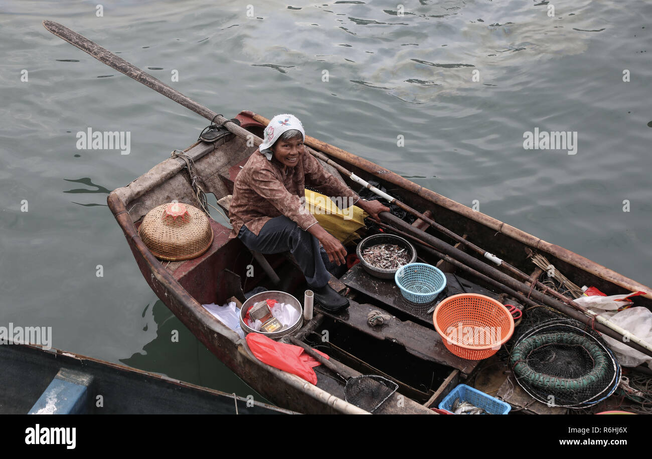 A woman sits in her fishing boat selling fresh fish in Aberdeen, Hong ...