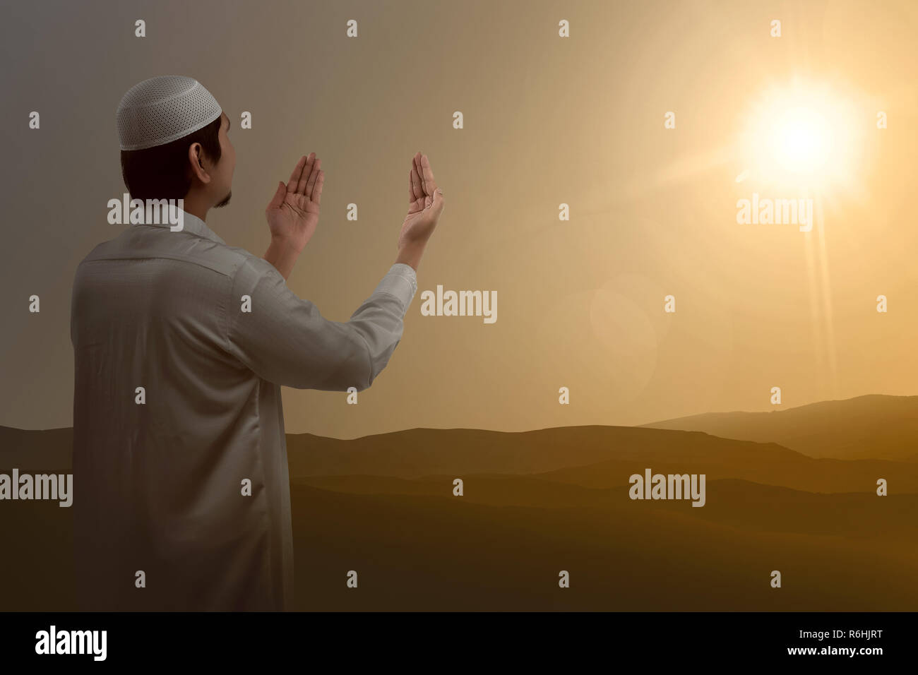 Back view of asian muslim raising hand and praying Stock Photo - Alamy