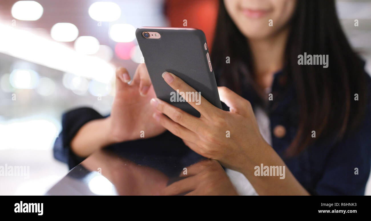 Working on mobile phone in the station Stock Photo - Alamy