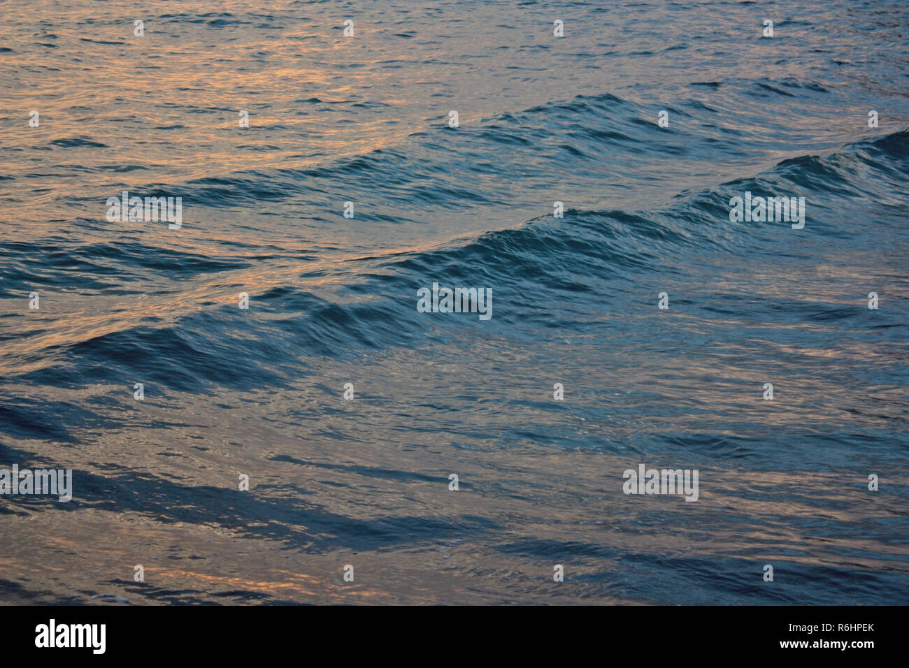 Wave in southern France at sunset. bright colours reflecting on the ...