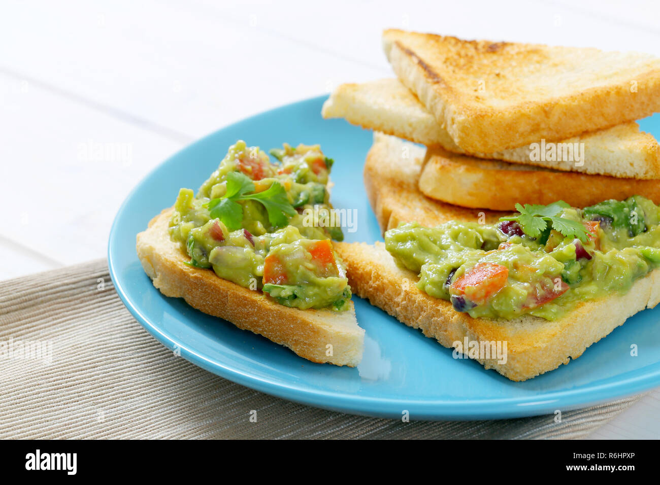 toasted bread with guacamole Stock Photo - Alamy