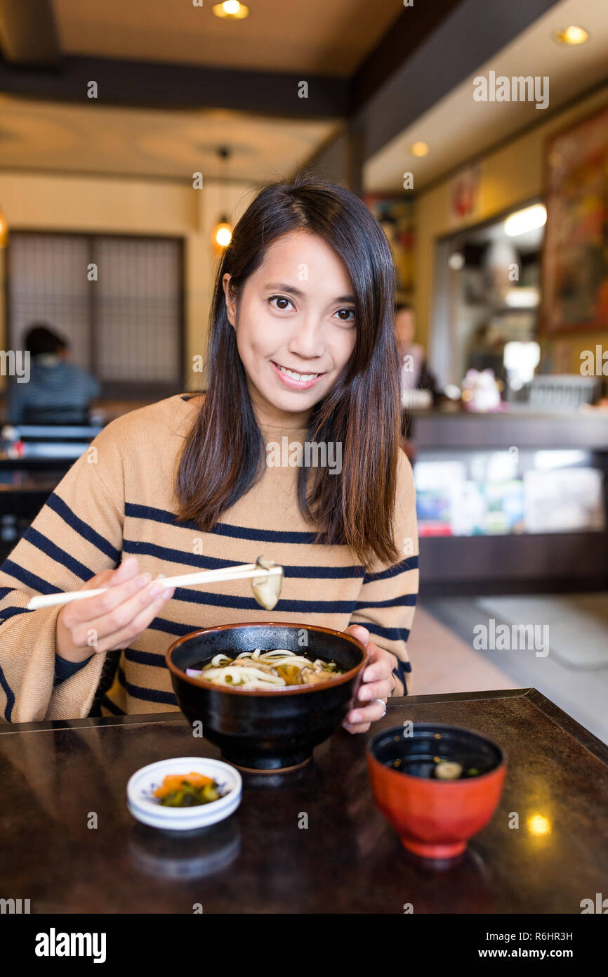 Woman eating udon in japanese restaurant Stock Photo - Alamy