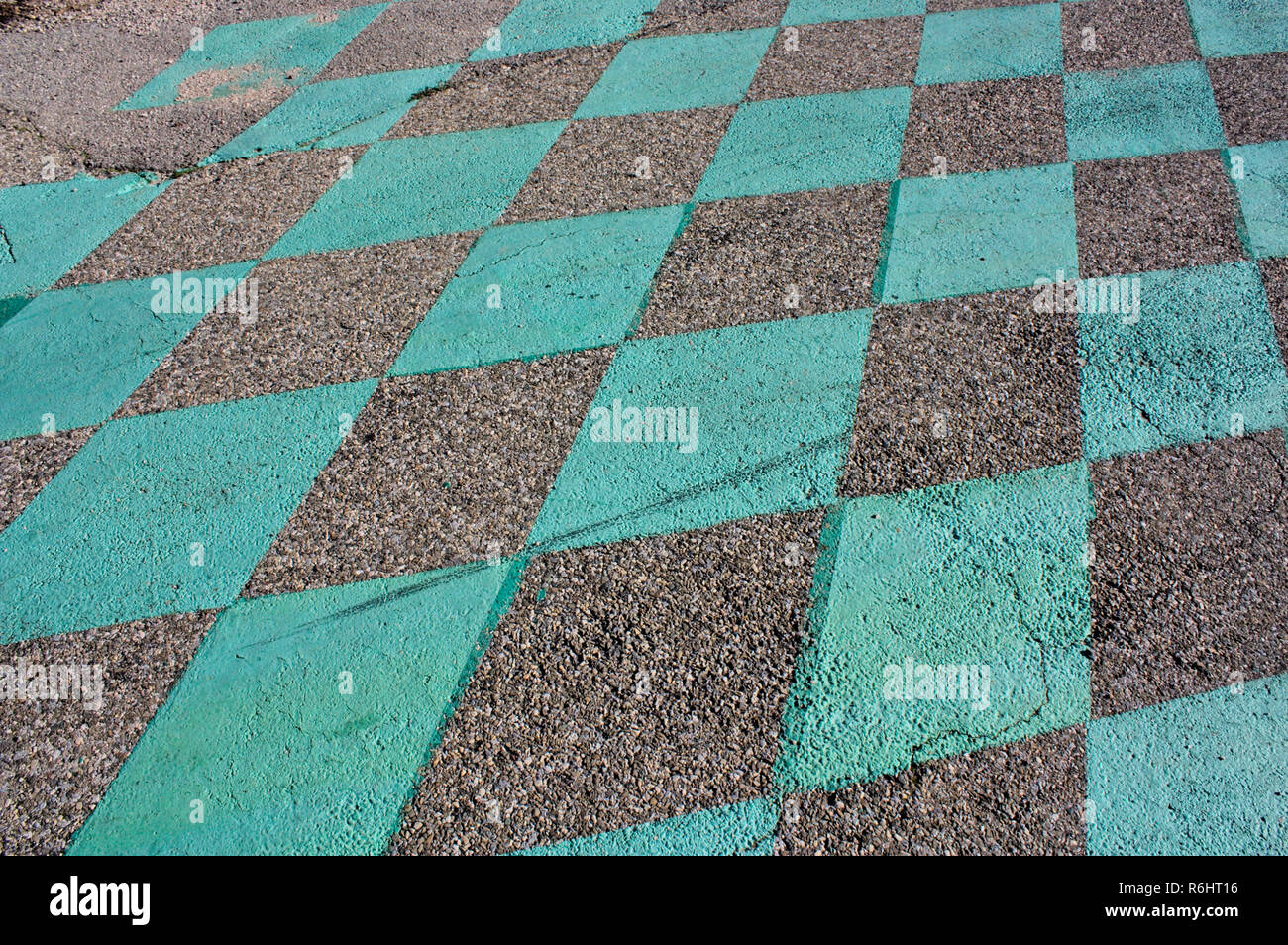 Pattern of green squares on asphalt. Looks like racing finish line ...
