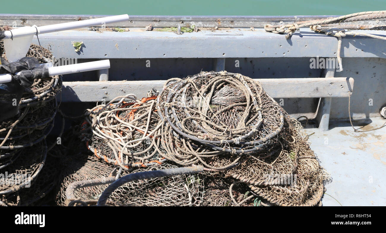 Fishing net in a boat without fisherman Stock Photo - Alamy