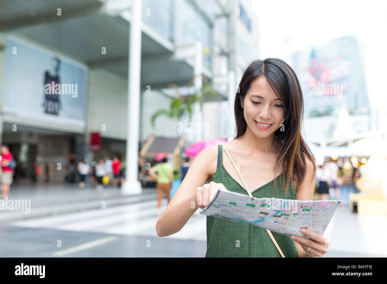 Tourist looking for destination with city map Stock Photo - Alamy
