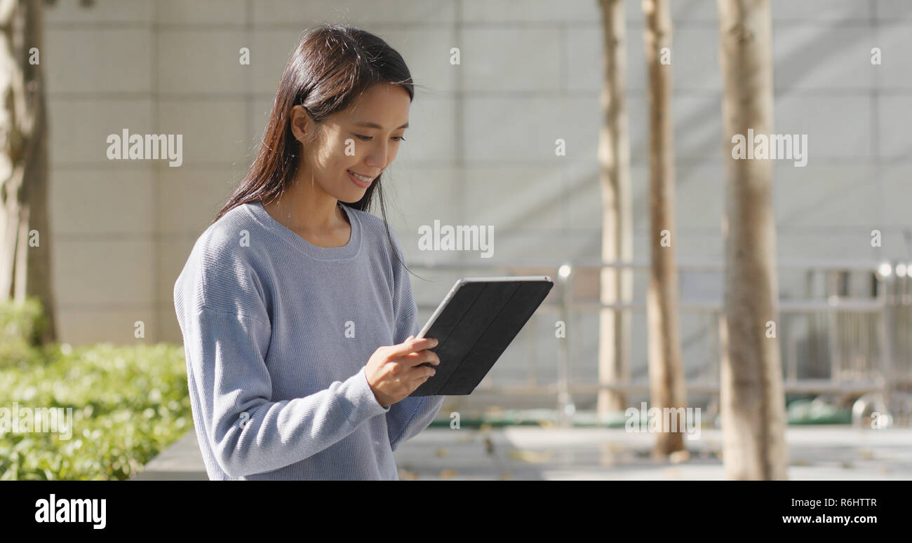 Woman look at tablet computer at outdoor Stock Photo - Alamy