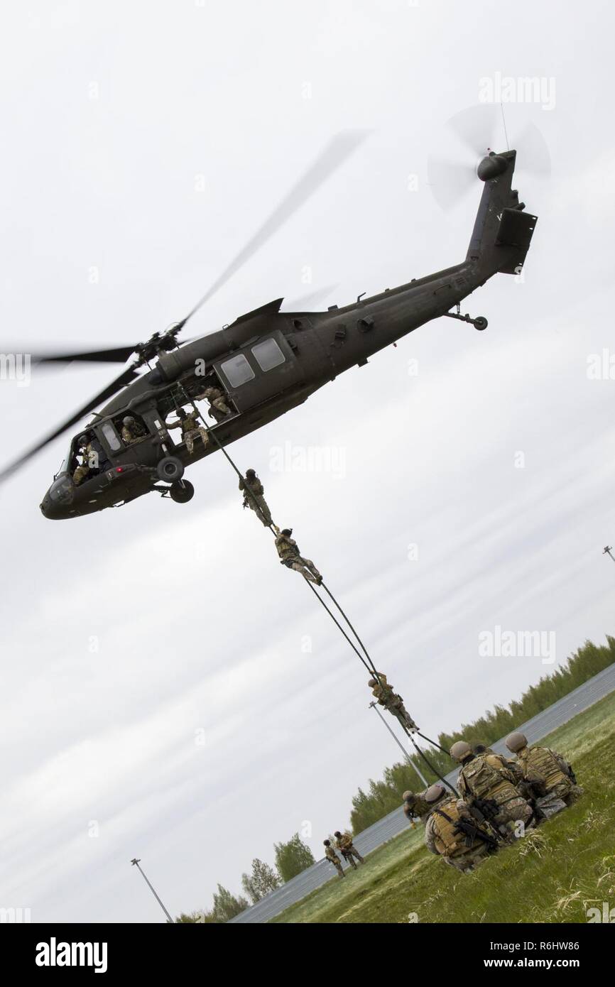 Soldiers from the Latvian Special Operations Forces (SOF) exit a UH-60 ...