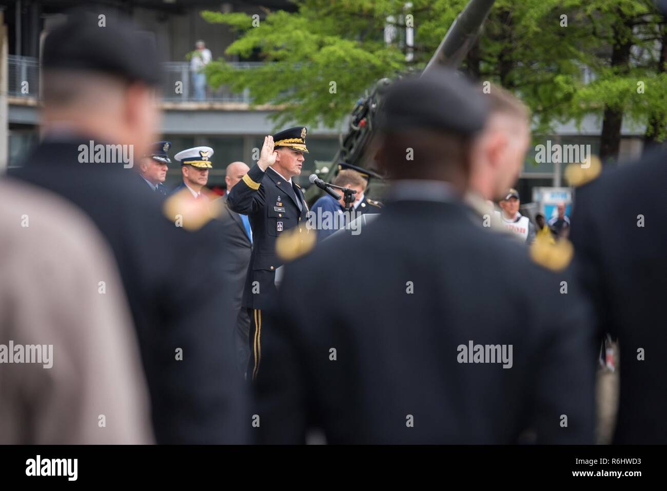 Maj. Gen. Courtney P. Carr renders the oath of enlistment to new ...