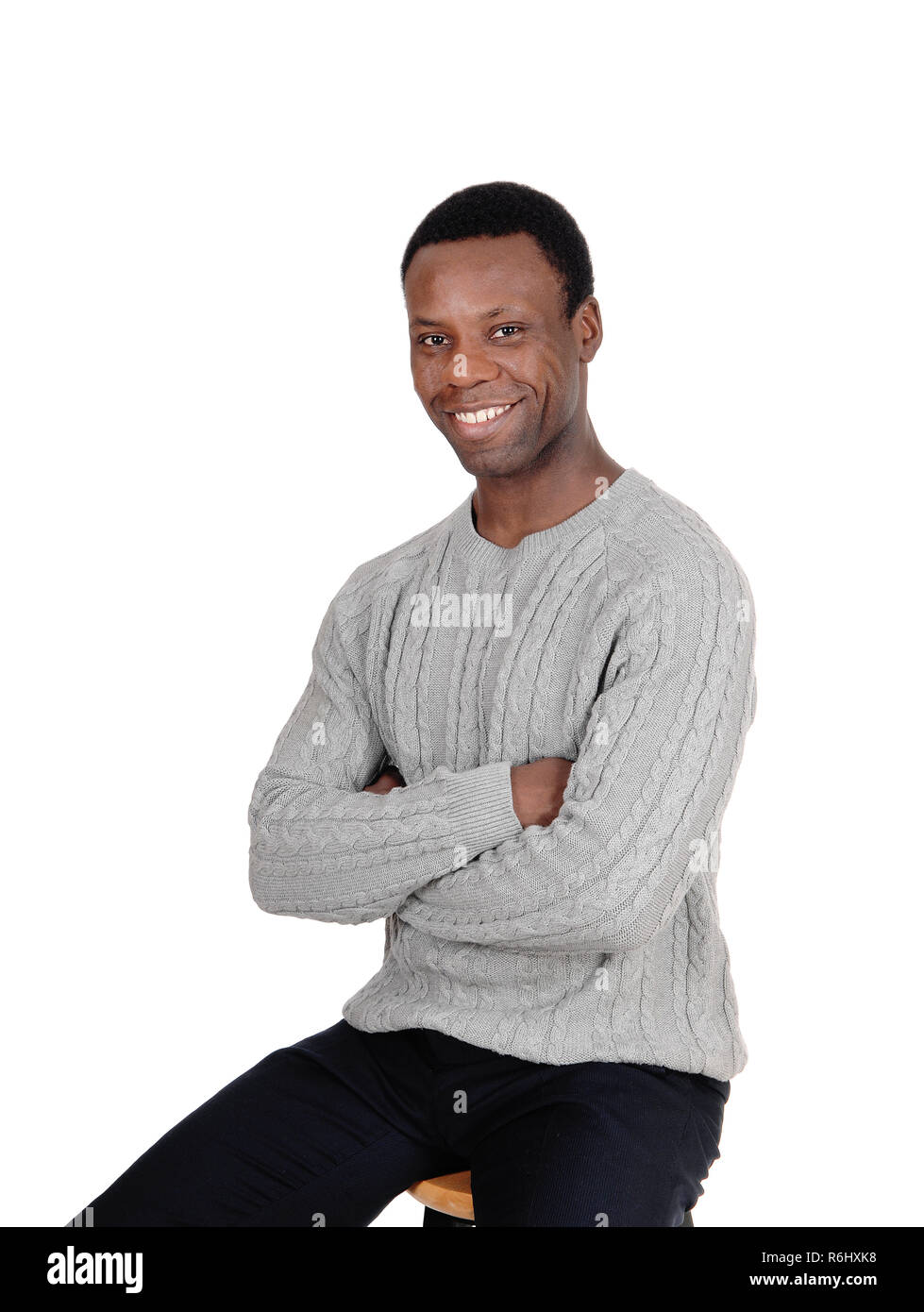 Happy African man smiling, sitting Stock Photo - Alamy