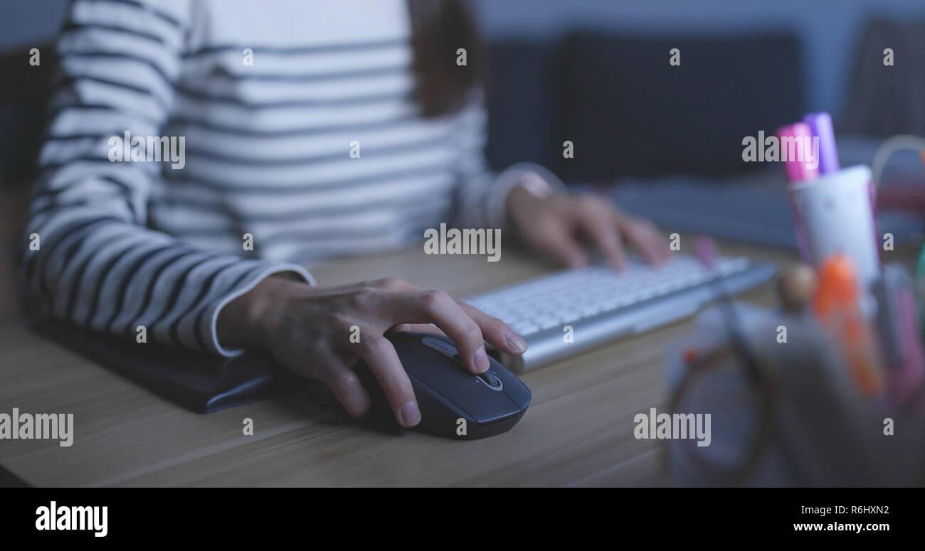 Woman using computer at night Stock Photo - Alamy