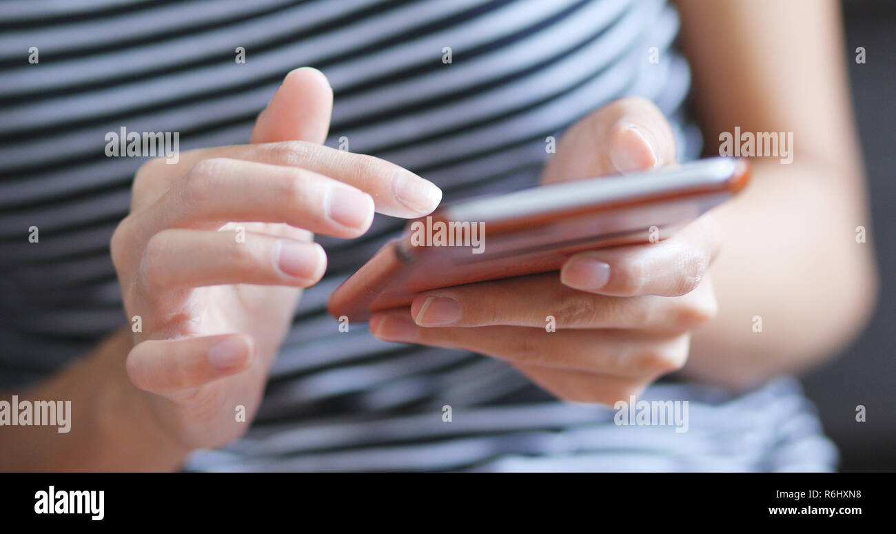 Using mobile phone at home Stock Photo - Alamy