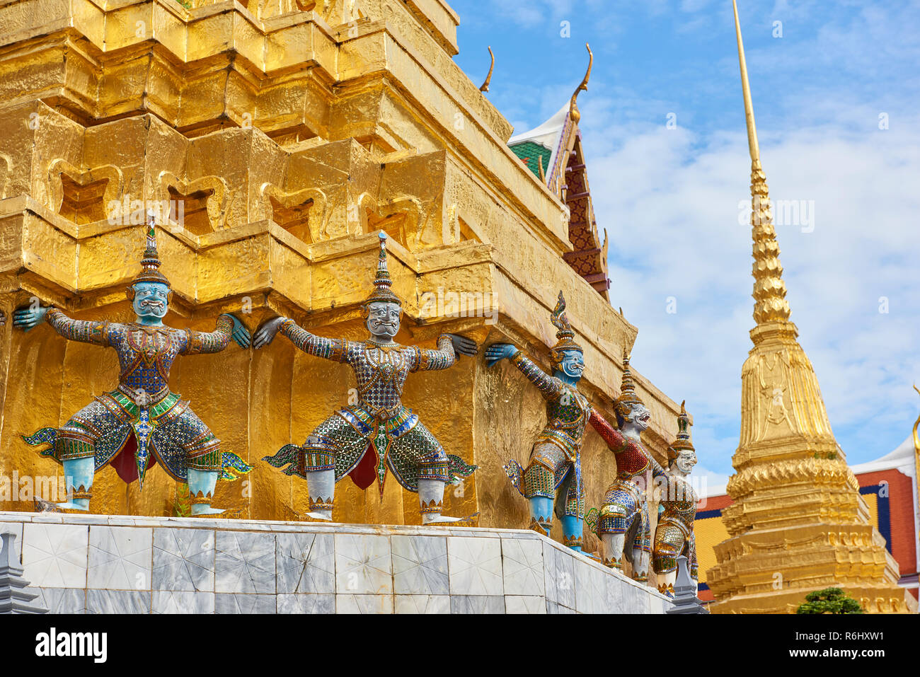 Golden Yaksha statues surrounding a pagoda in the Grand Palace in ...