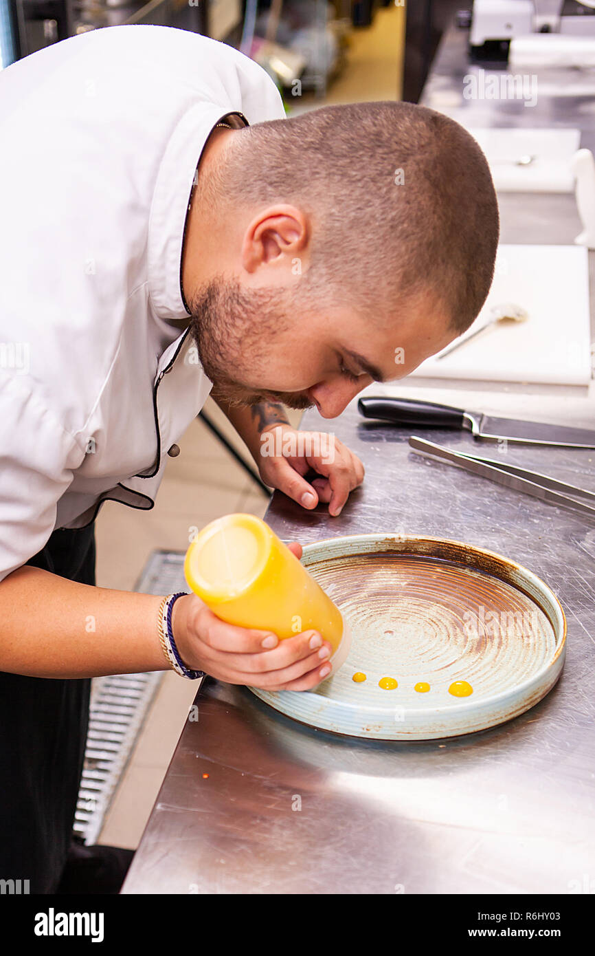 Chef preparing food meal in kitchen restaurant. Chef decorating dish ...