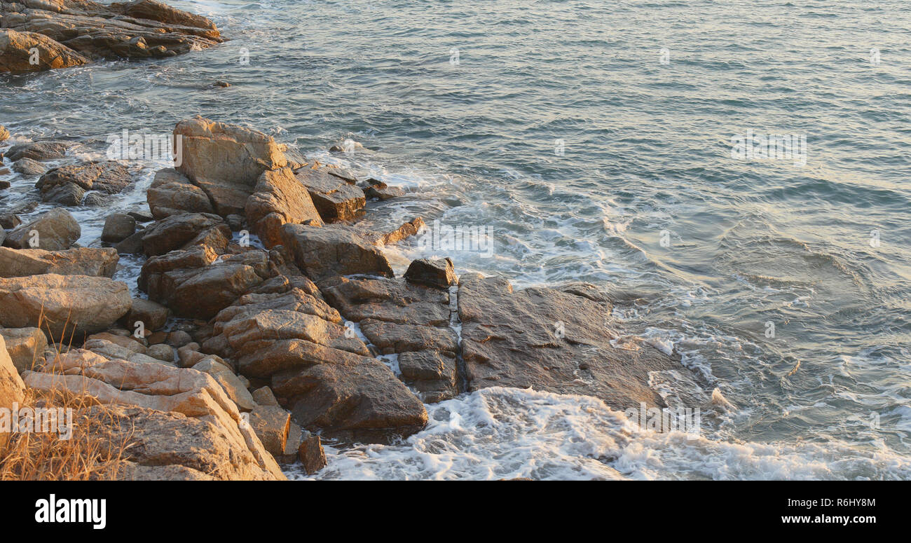 Sea wave and rock Stock Photo - Alamy