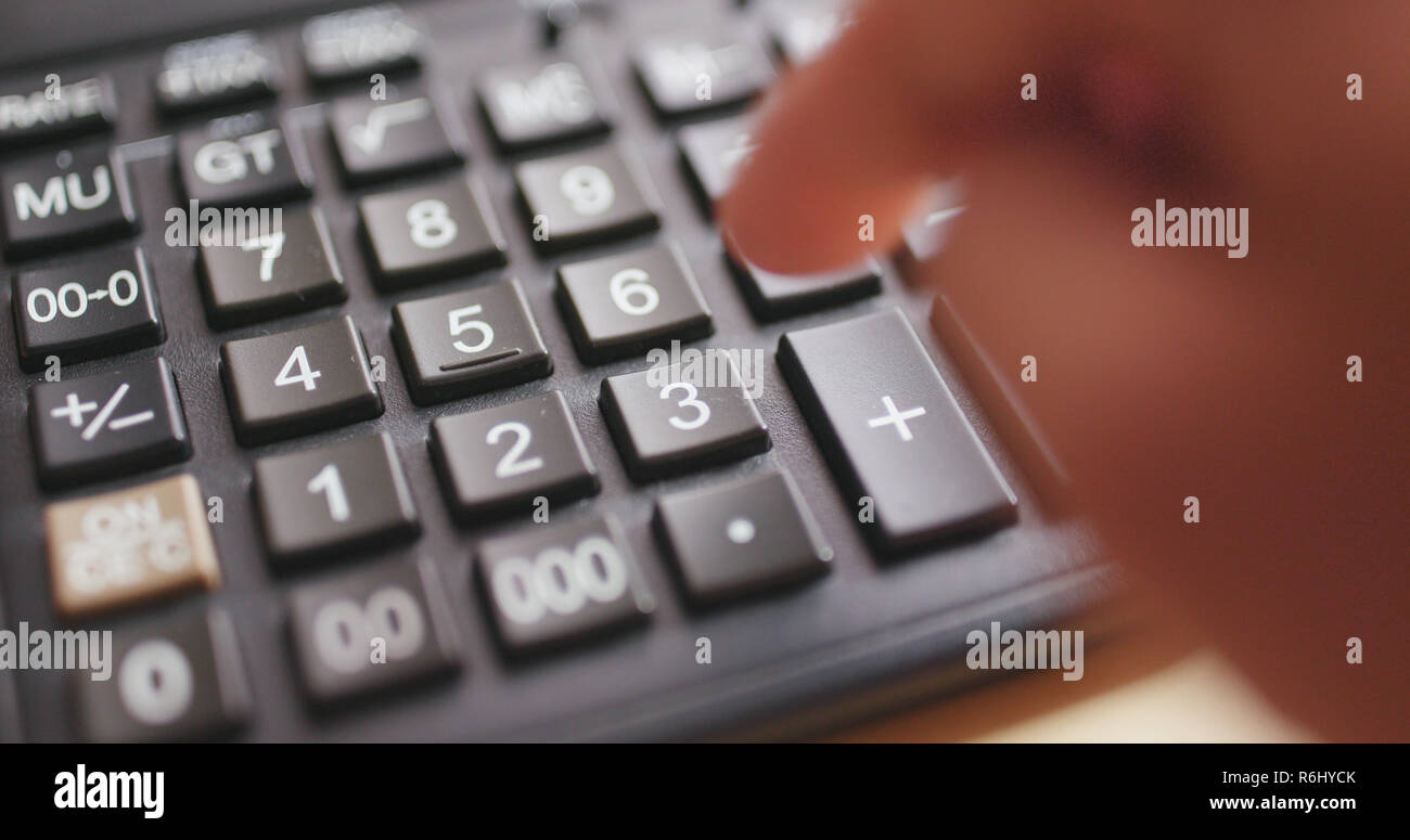 Counting on calculator Stock Photo - Alamy