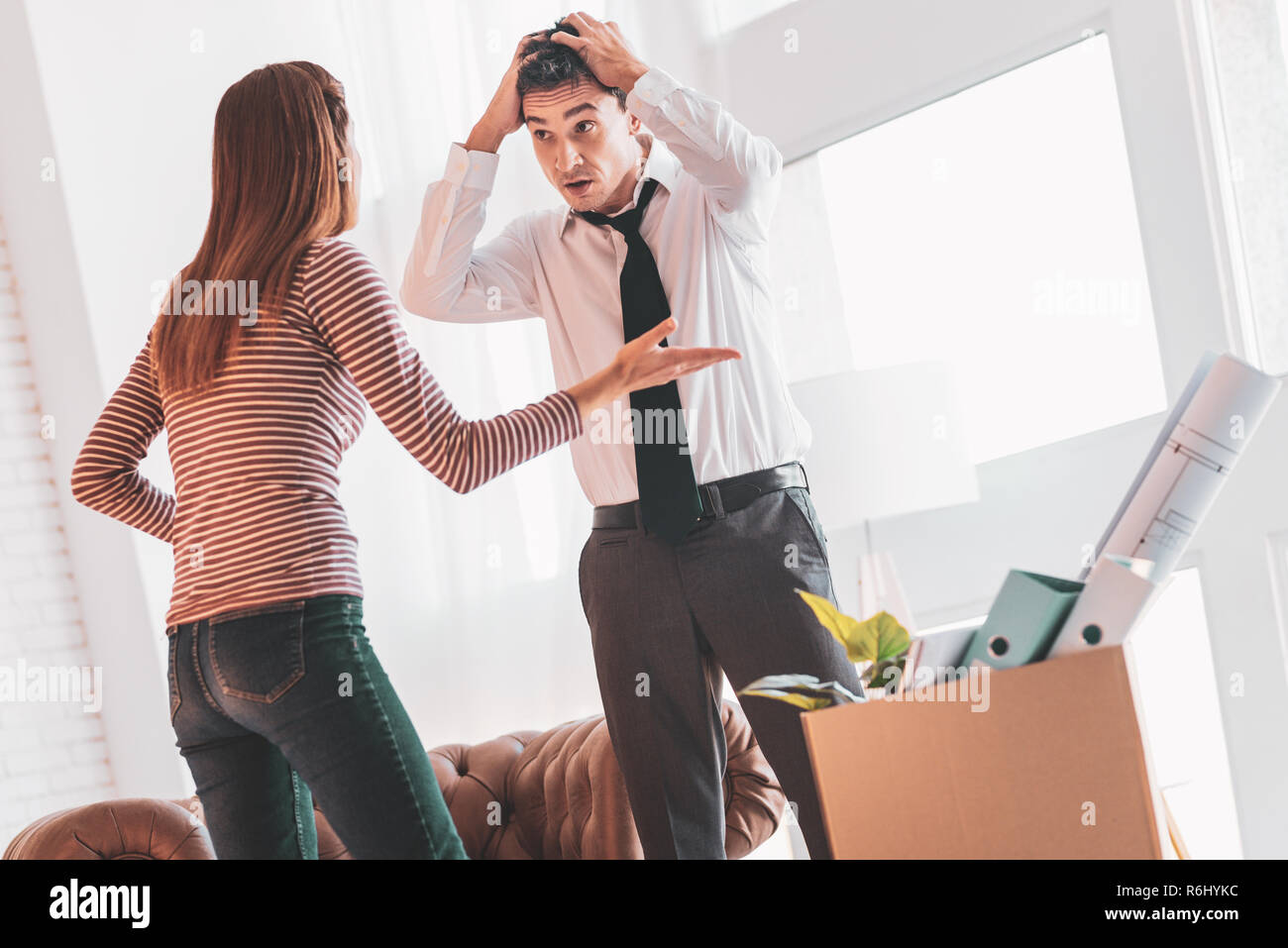 Upset man losing his job and his wife feeling angry Stock Photo - Alamy