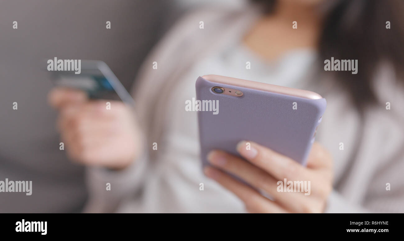 Using mobile phone for online shopping at home Stock Photo - Alamy