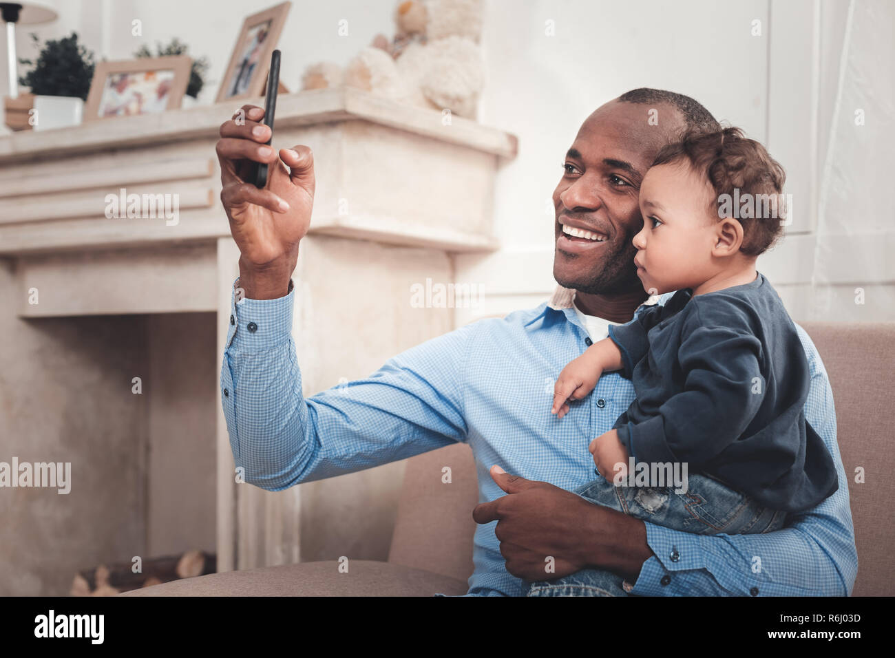 Happy positive man taking a selfie Stock Photo - Alamy