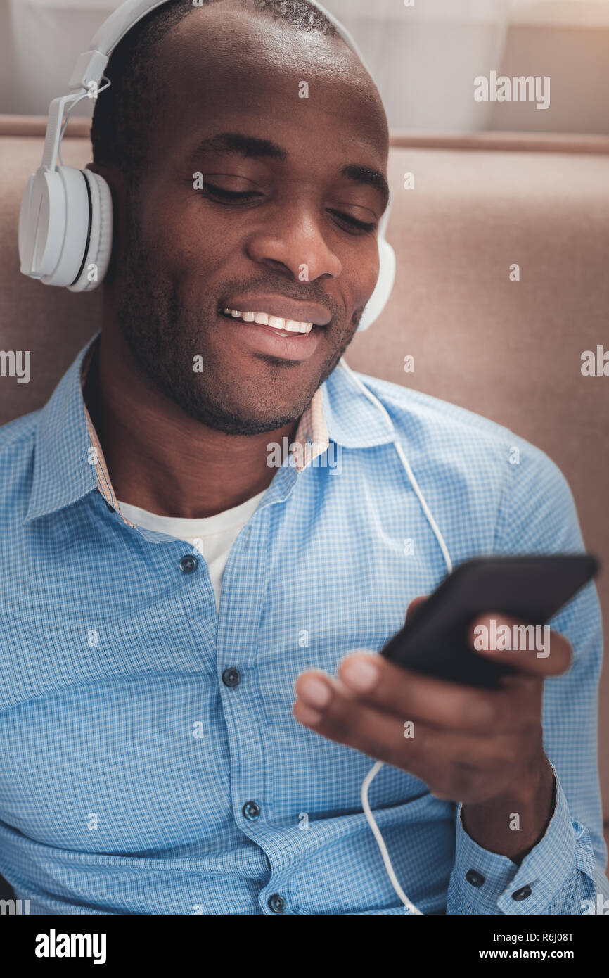 Cheerful positive man looking at the smartphone screen Stock Photo - Alamy Cheerful positive man looking at the smartphone screen Stock Photo - Alamy