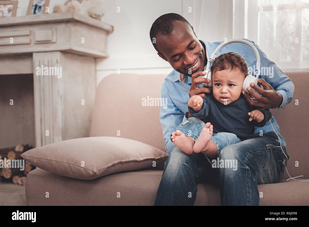 Delighted positive man holding his baby Stock Photo - Alamy