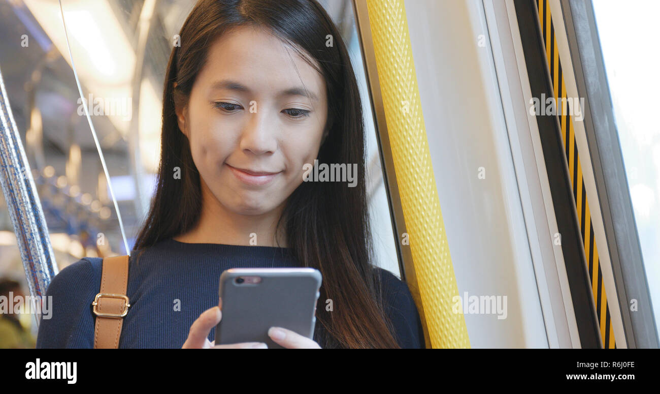 Woman use of cellphone inside train compartment Stock Photo - Alamy