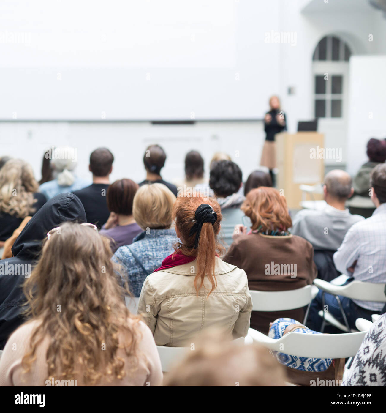 Woman giving presentation on business conference Stock Photo - Alamy