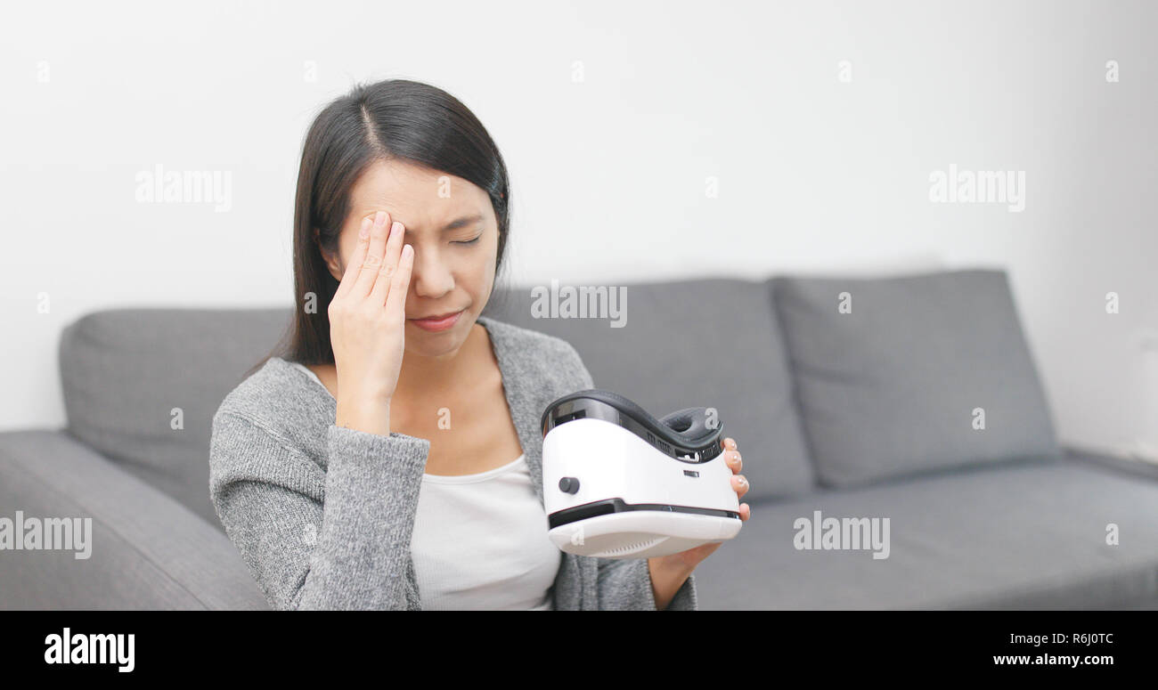 Woman feeling dizzy after playing VR device Stock Photo - Alamy