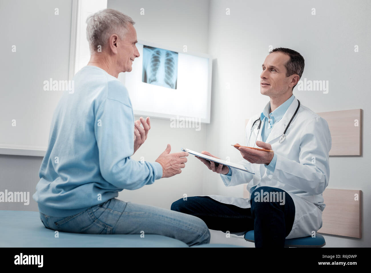Competent practitioner examining his patient Stock Photo - Alamy