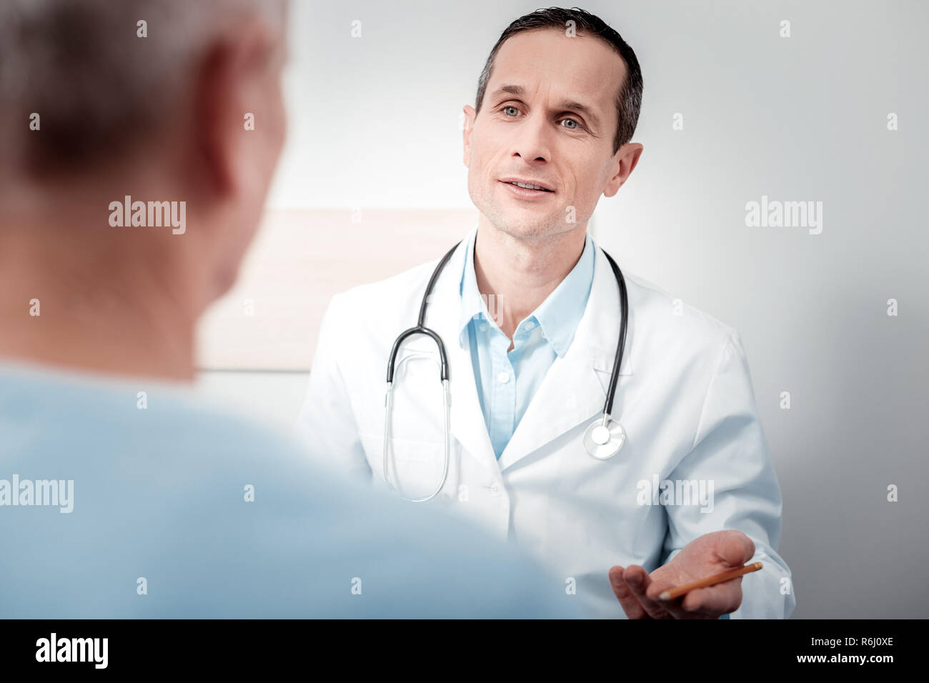 Professional physician talking to his patient Stock Photo - Alamy