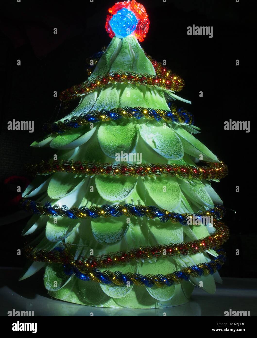 Homemade Christmas tree. The tree is made of plastic forks and spoons ...