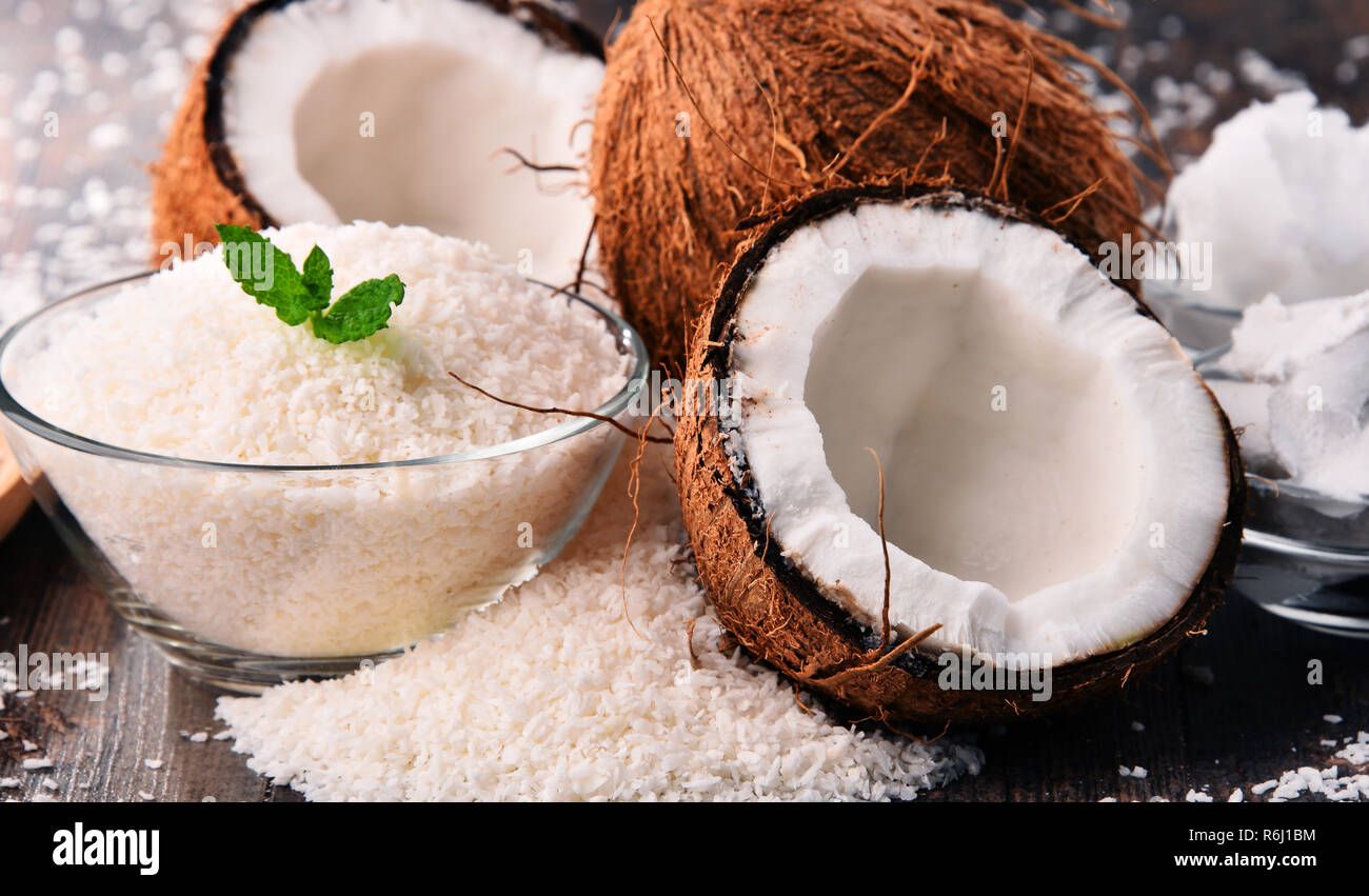 Composition with bowl of shredded coconut and shells Stock Photo - Alamy