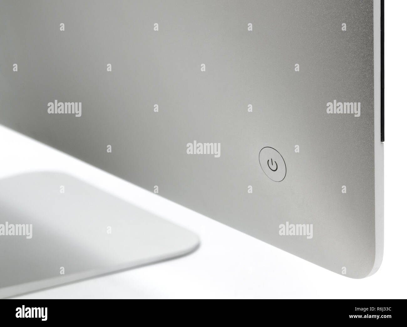 Power button on aluminium computer all in one, on a white background ...