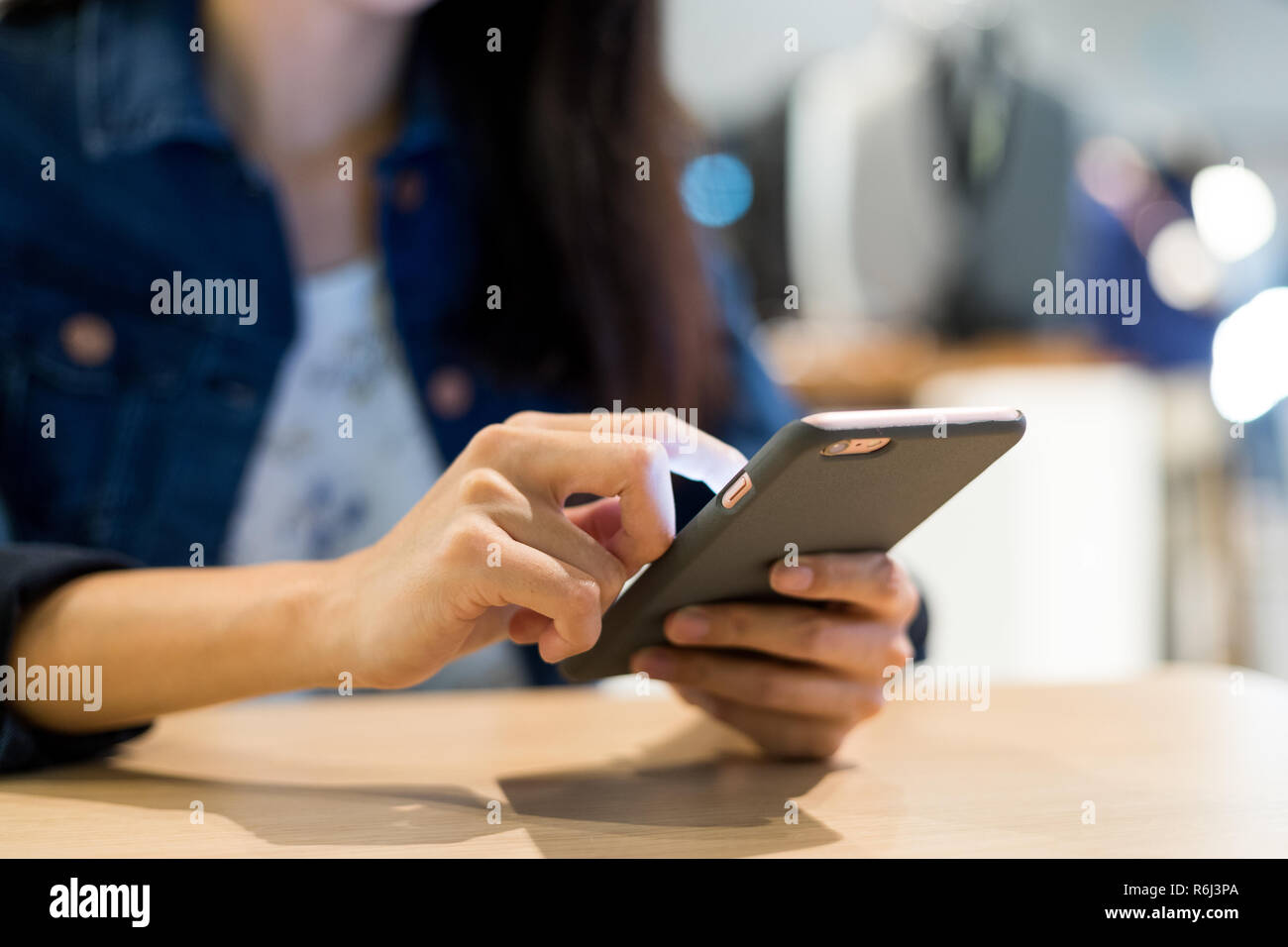 Using mobile phone in restaurant Stock Photo - Alamy
