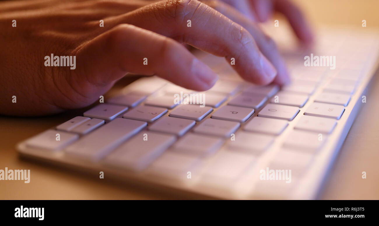 Typing on laptop computer Stock Photo - Alamy