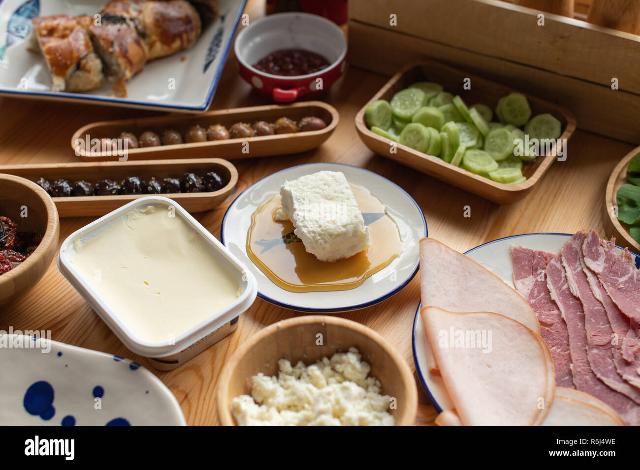 Traditional Turkish Breakfast, eggs with sucuk, bal kaymak, olives, ham ...