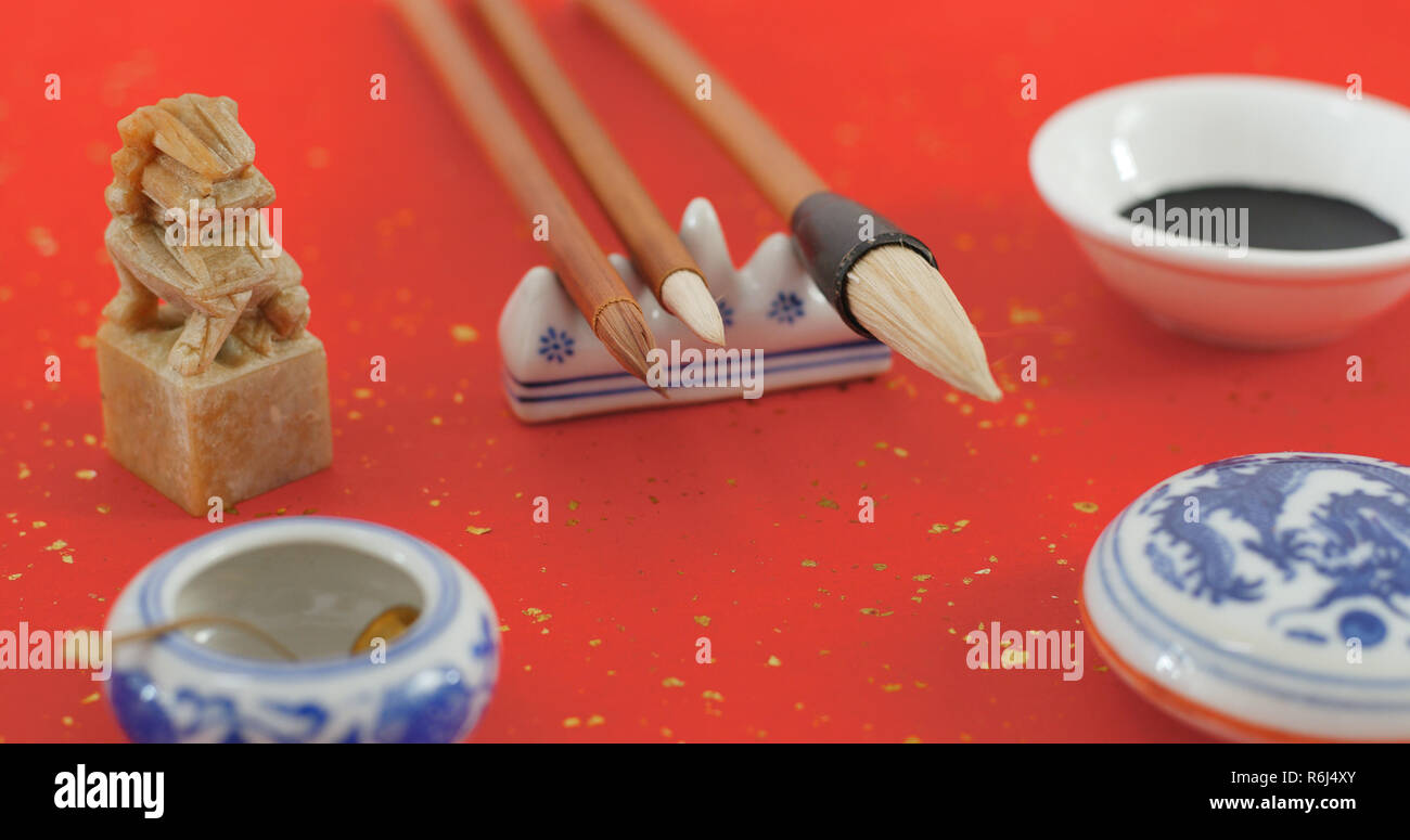 Dipping black ink for writing Chinese calligraphy for lunar new year ...