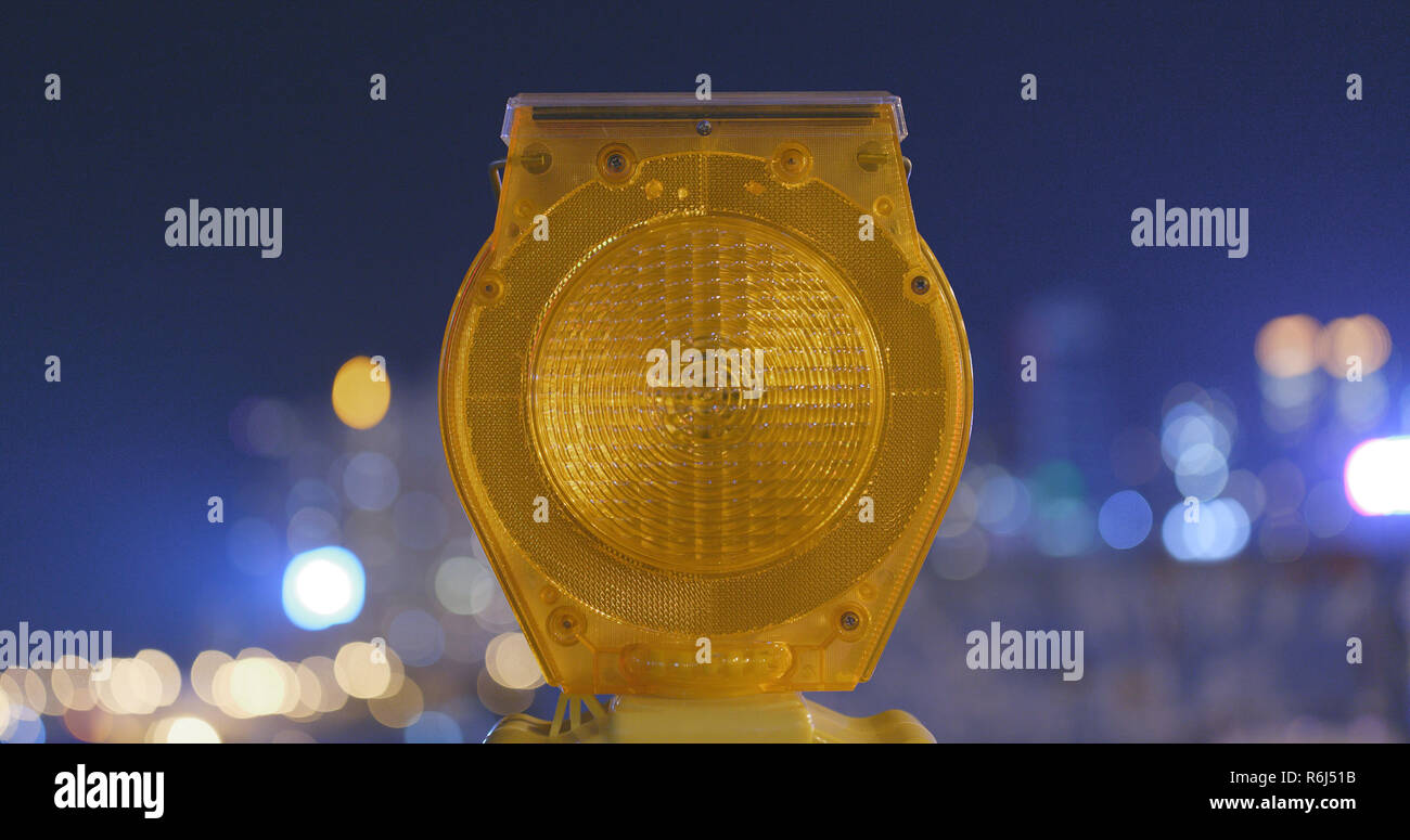 Safety Caution yellow light in the city at night Stock Photo - Alamy