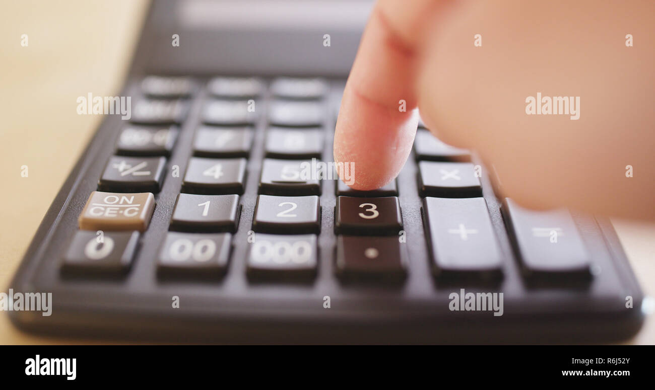 Counting on calculator Stock Photo - Alamy